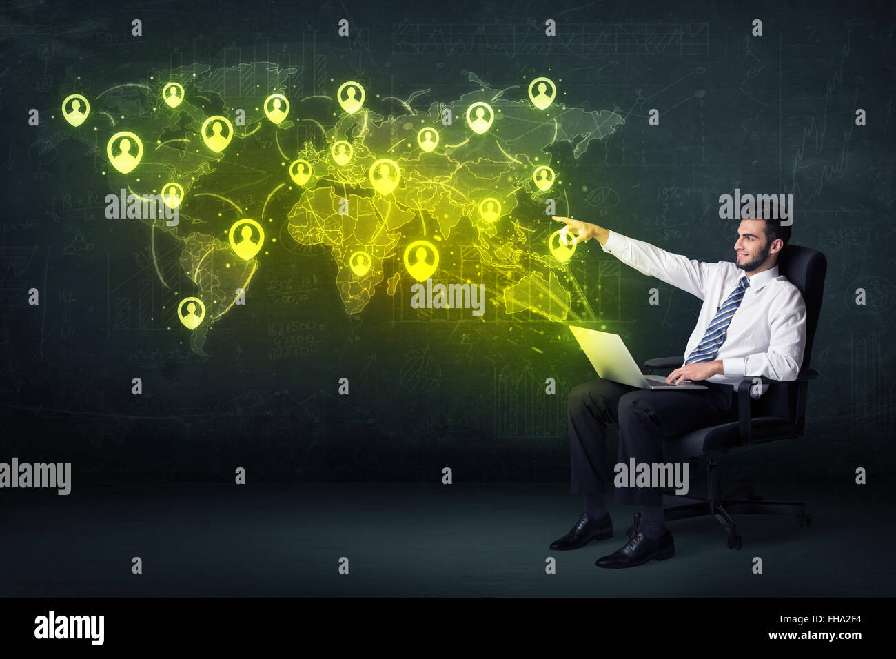 Businessman in office with laptop and social network world map Stock ...