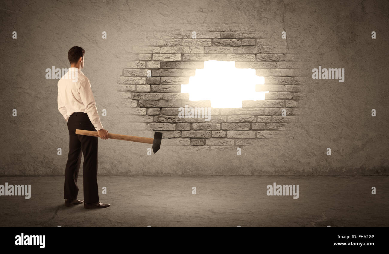 Business man hitting brick wall with hammer and opening a hole Stock ...