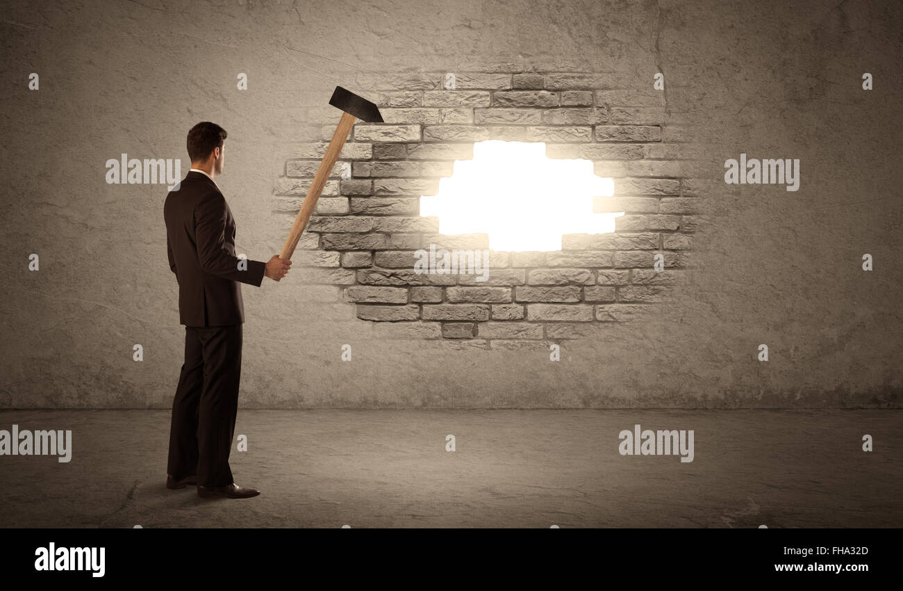 Business man hitting brick wall with hammer and opening a hole Stock ...