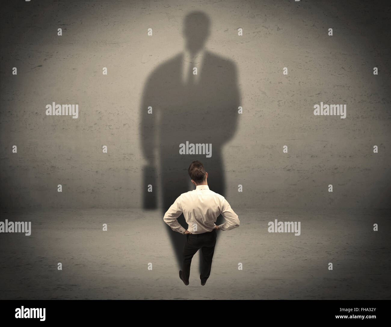 Businessman looking at big shadow concept Stock Photo - Alamy