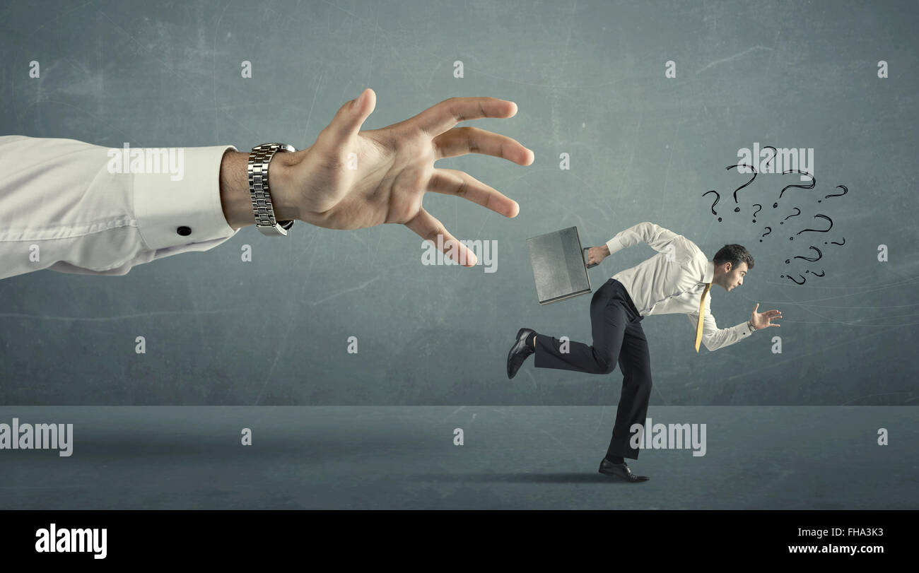 Businessman running away from a big hand Stock Photo - Alamy