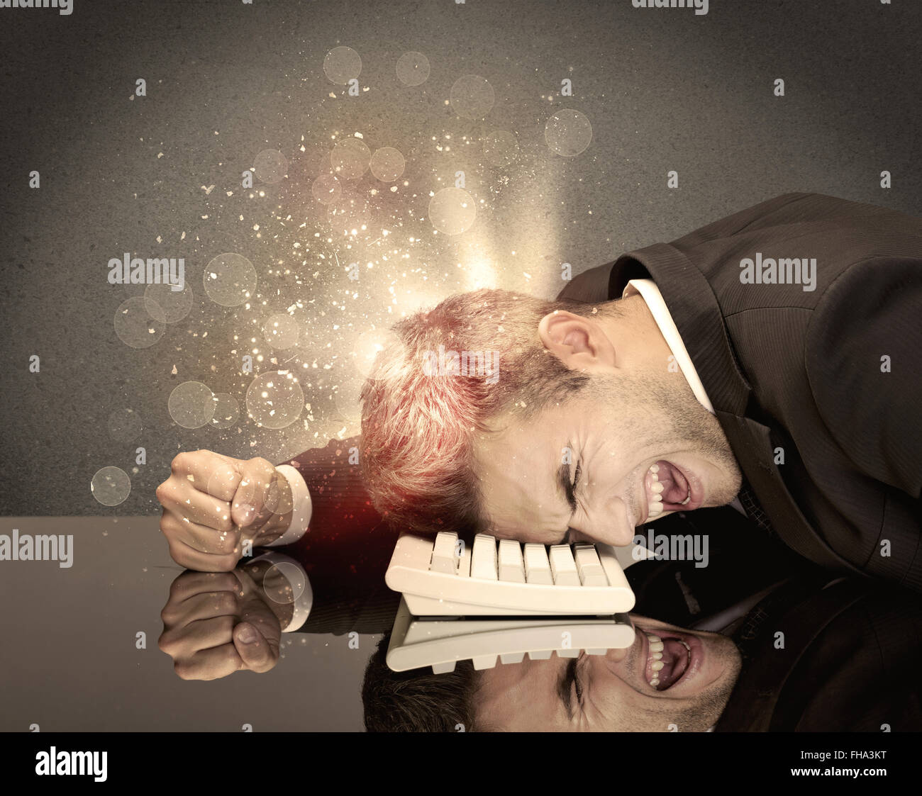Angry businessman with lights and keyboard Stock Photo - Alamy