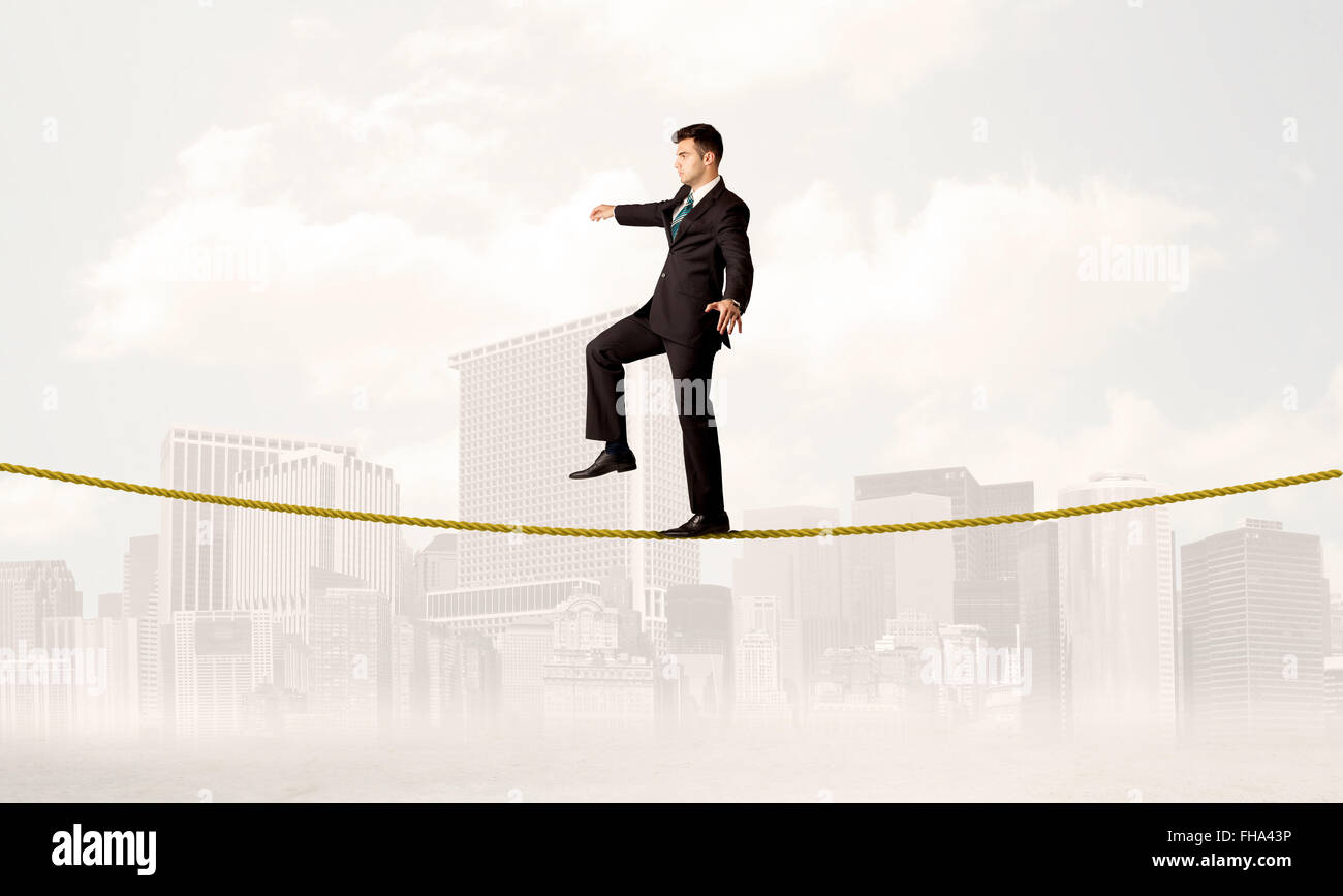 Business person balancing on golden rope Stock Photo - Alamy