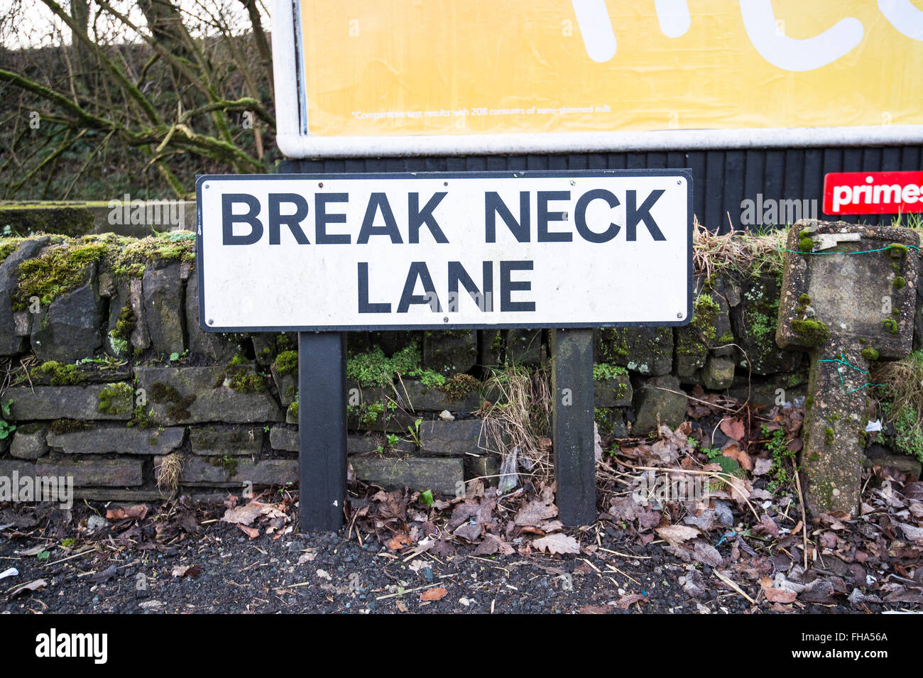 Break Neck Lane road sign in front of low stone wall Stock Photo - Alamy