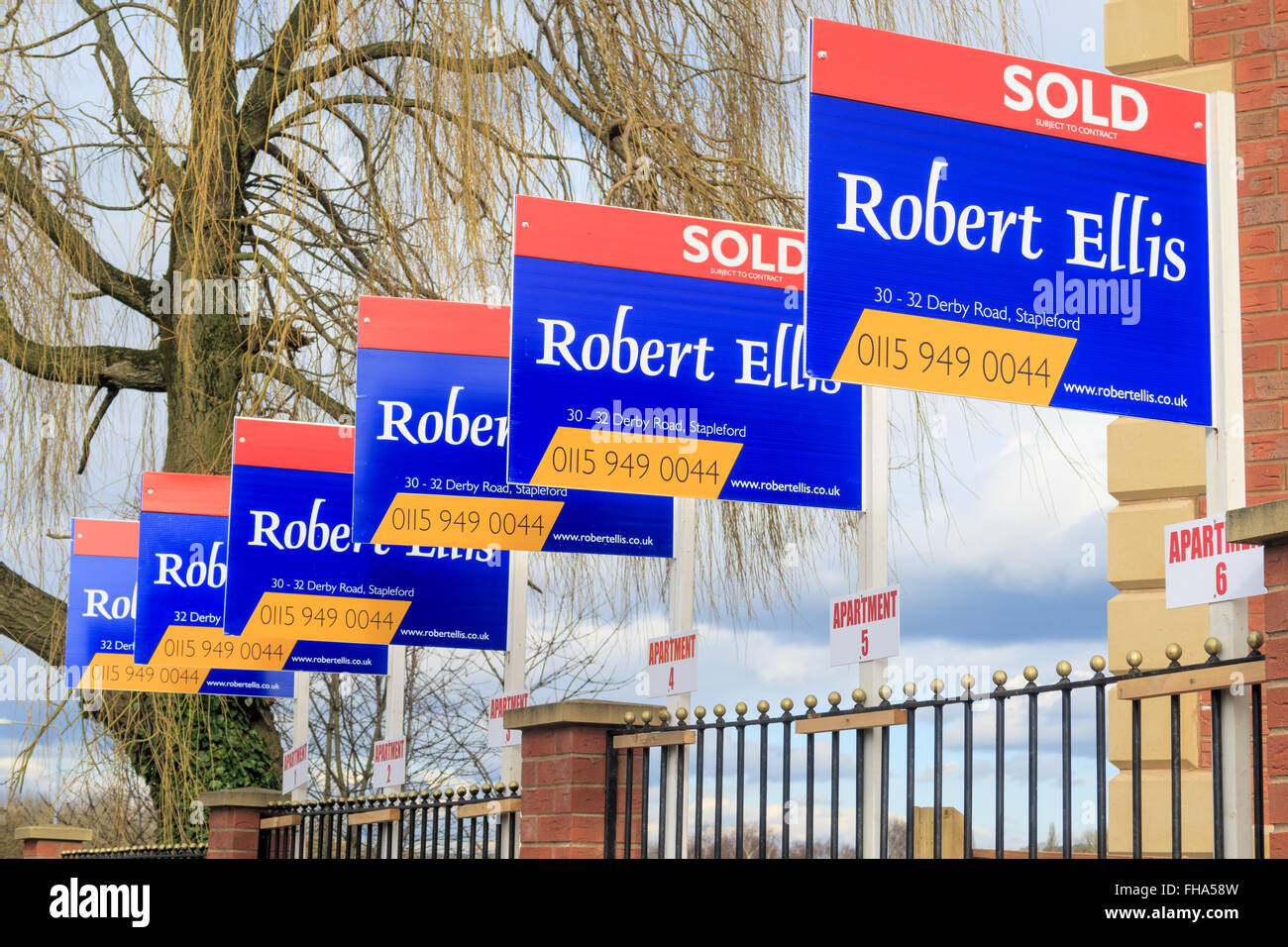 A row of estate agent house 'sold' signs. In Awsworth, Nottinghamshire ...