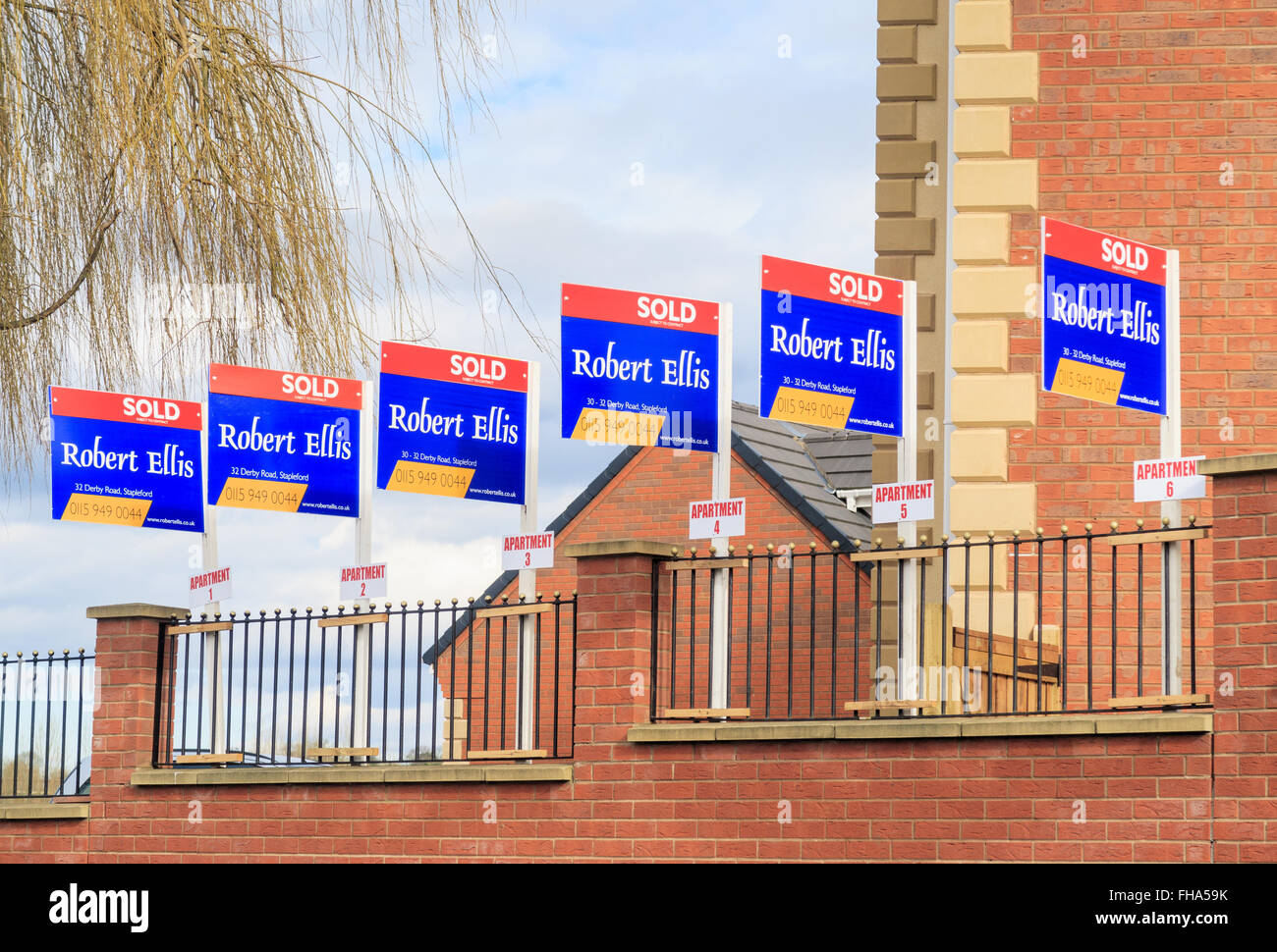A row of 'Robert Ellis' estate agent house 'sold' signs Stock Photo - Alamy