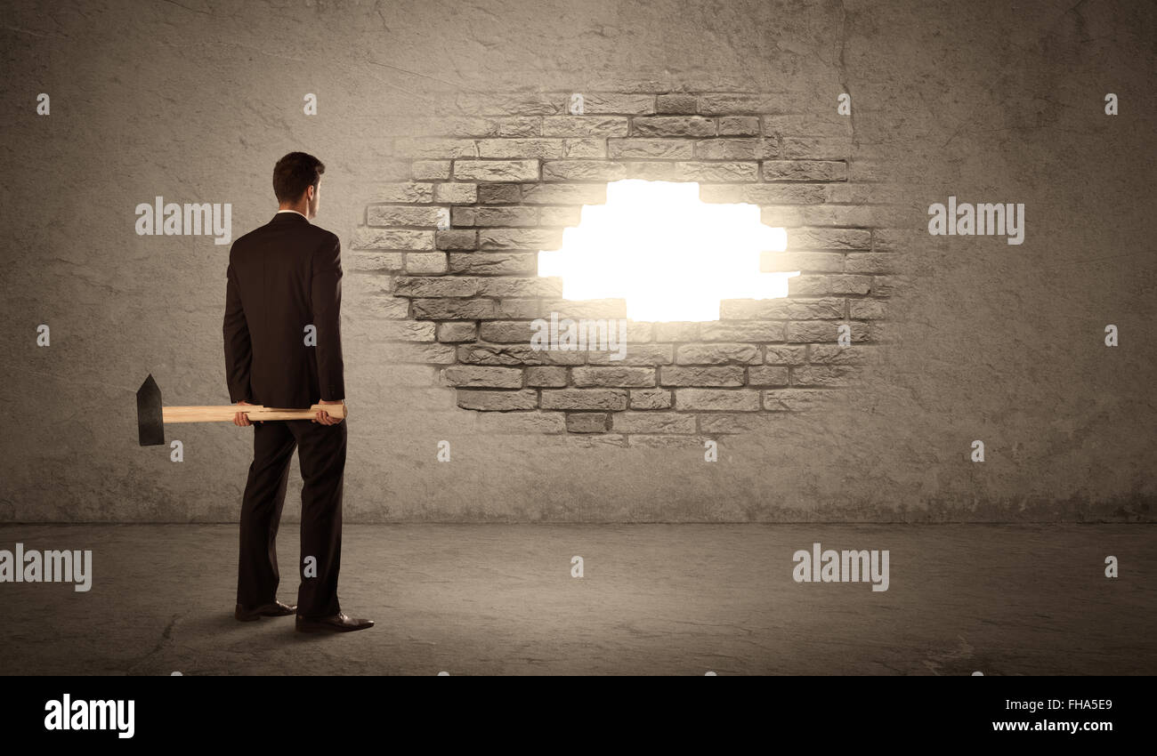 Business man hitting brick wall with hammer and opening a hole Stock ...