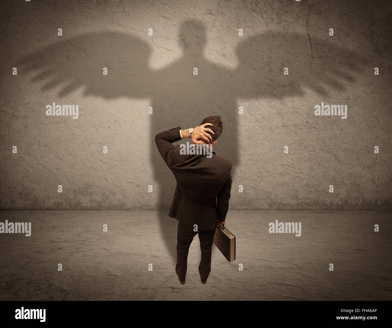 Honest salesman with angel shadow concept Stock Photo - Alamy