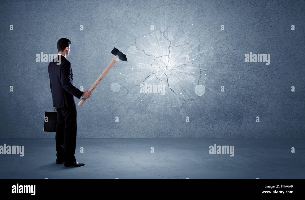 Business man hitting wall with a hammer Stock Photo - Alamy