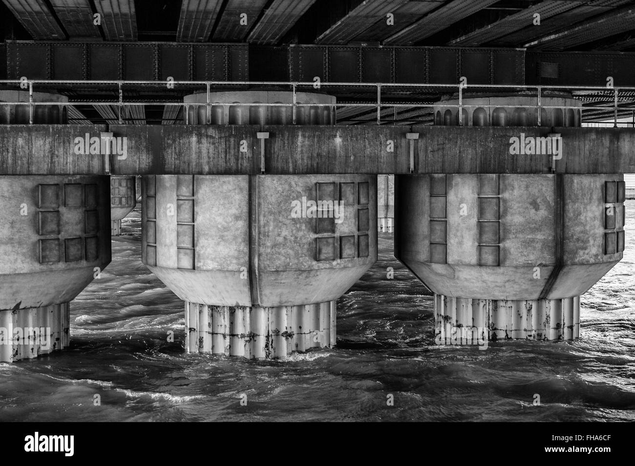 Bridge supporting columns rising out of river Stock Photo - Alamy