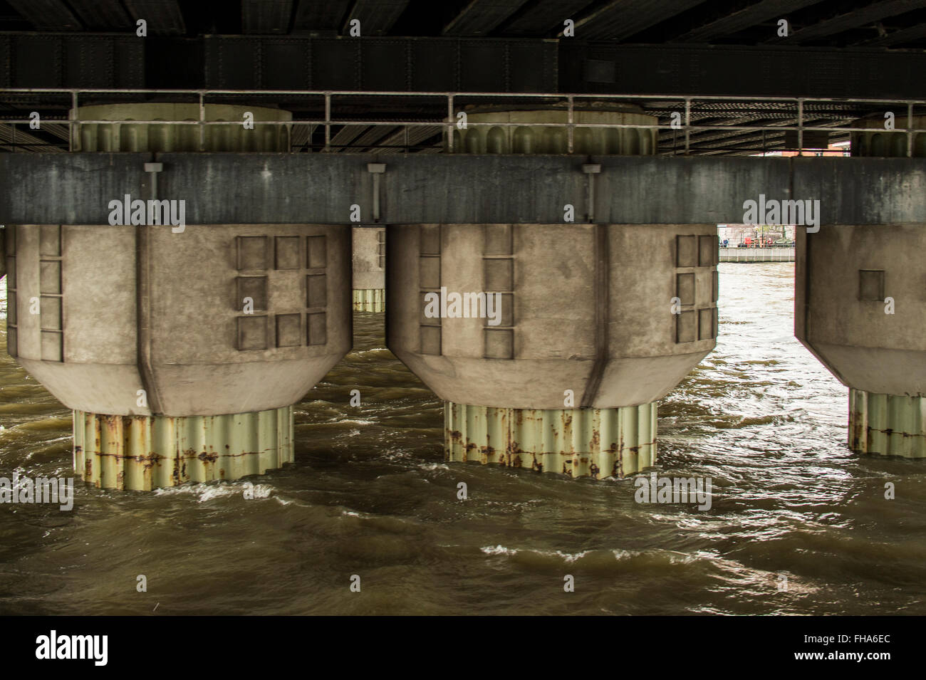 Bridge supporting columns rising out of river Stock Photo - Alamy