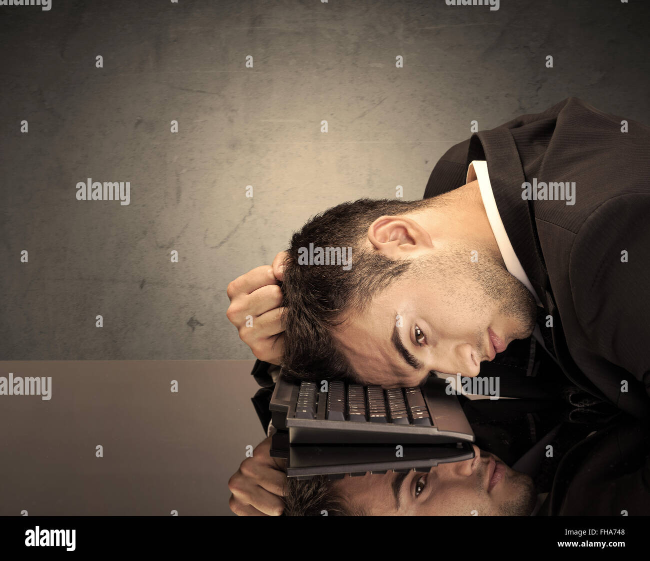 Frustrated businessman's head on keyboard Stock Photo - Alamy