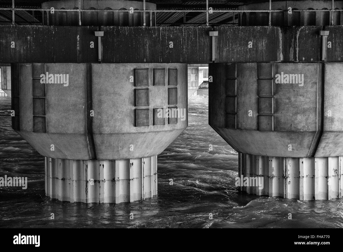 Bridge supporting columns rising out of river Stock Photo - Alamy