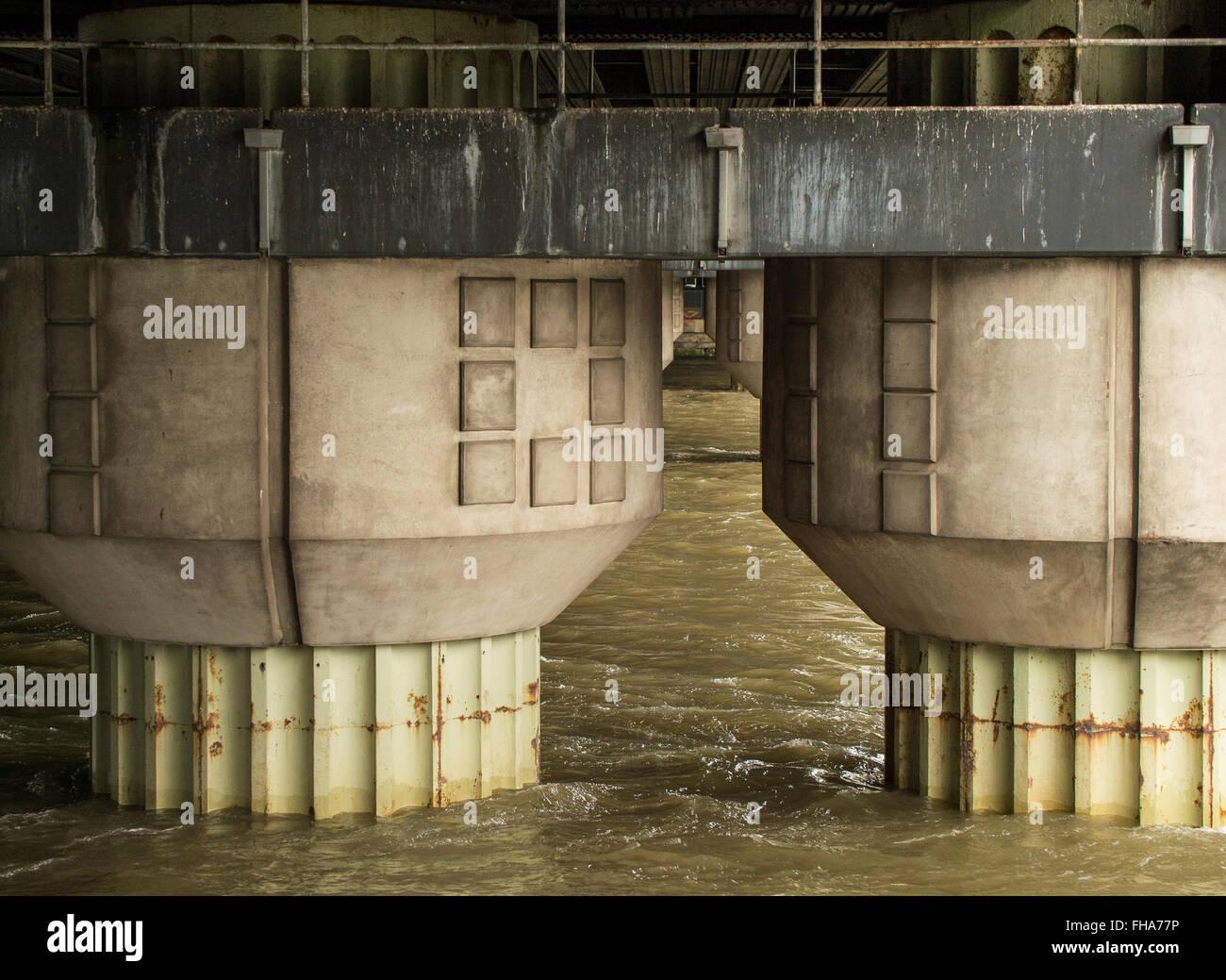 Bridge supporting columns rising out of river Stock Photo - Alamy