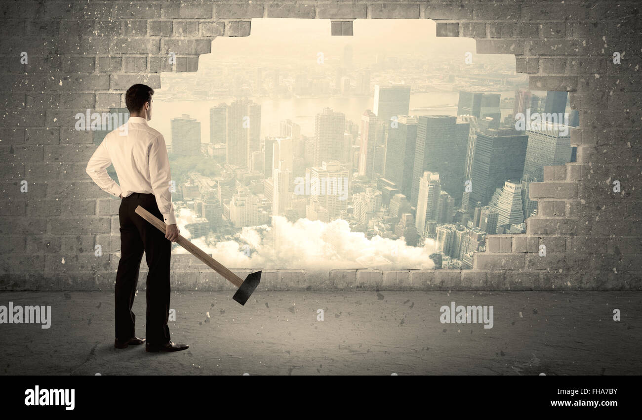 Business man hitting wall with hammer on city view Stock Photo - Alamy
