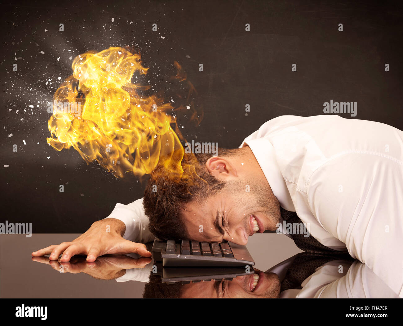 Stressed business man's head is burning Stock Photo - Alamy
