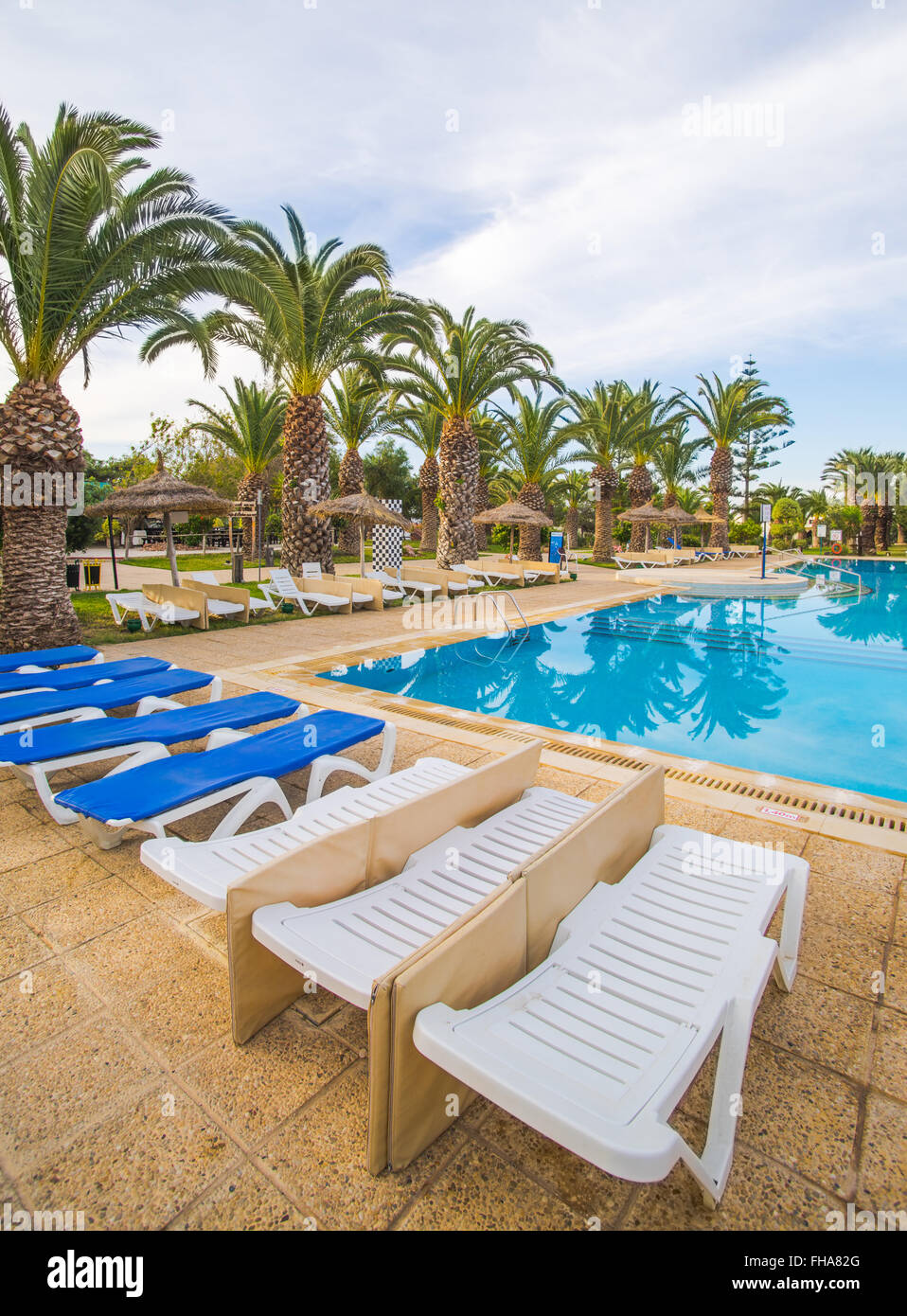 swimming pool and deck chairs at luxury resort. Summer Vacation Stock ...