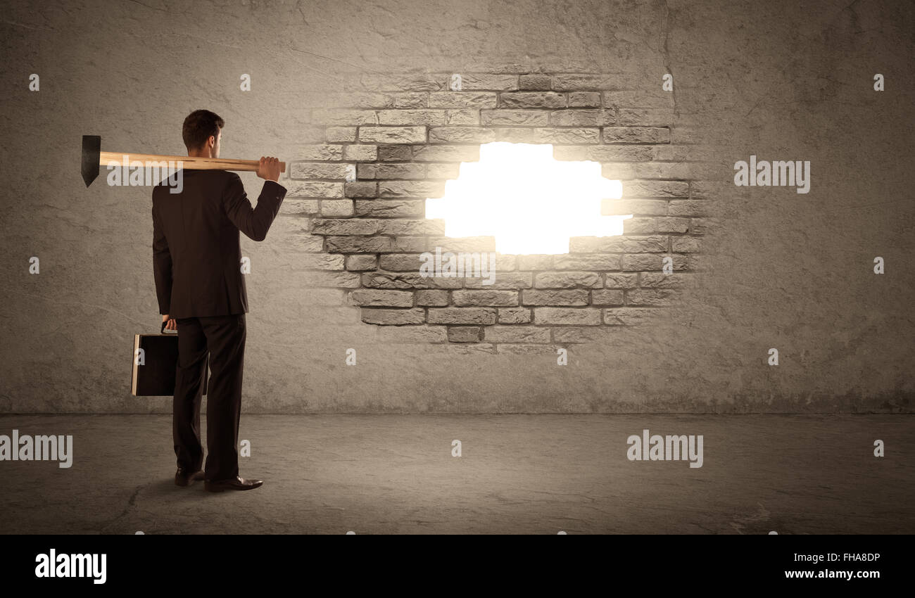 Business man hitting brick wall with hammer and opening a hole Stock ...