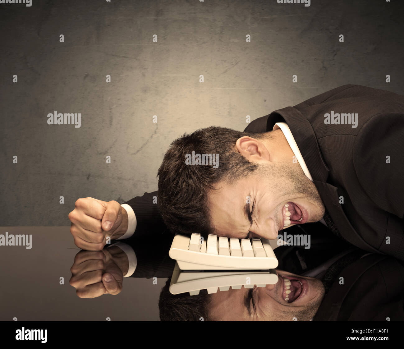 Frustrated businessman's head on keyboard Stock Photo - Alamy