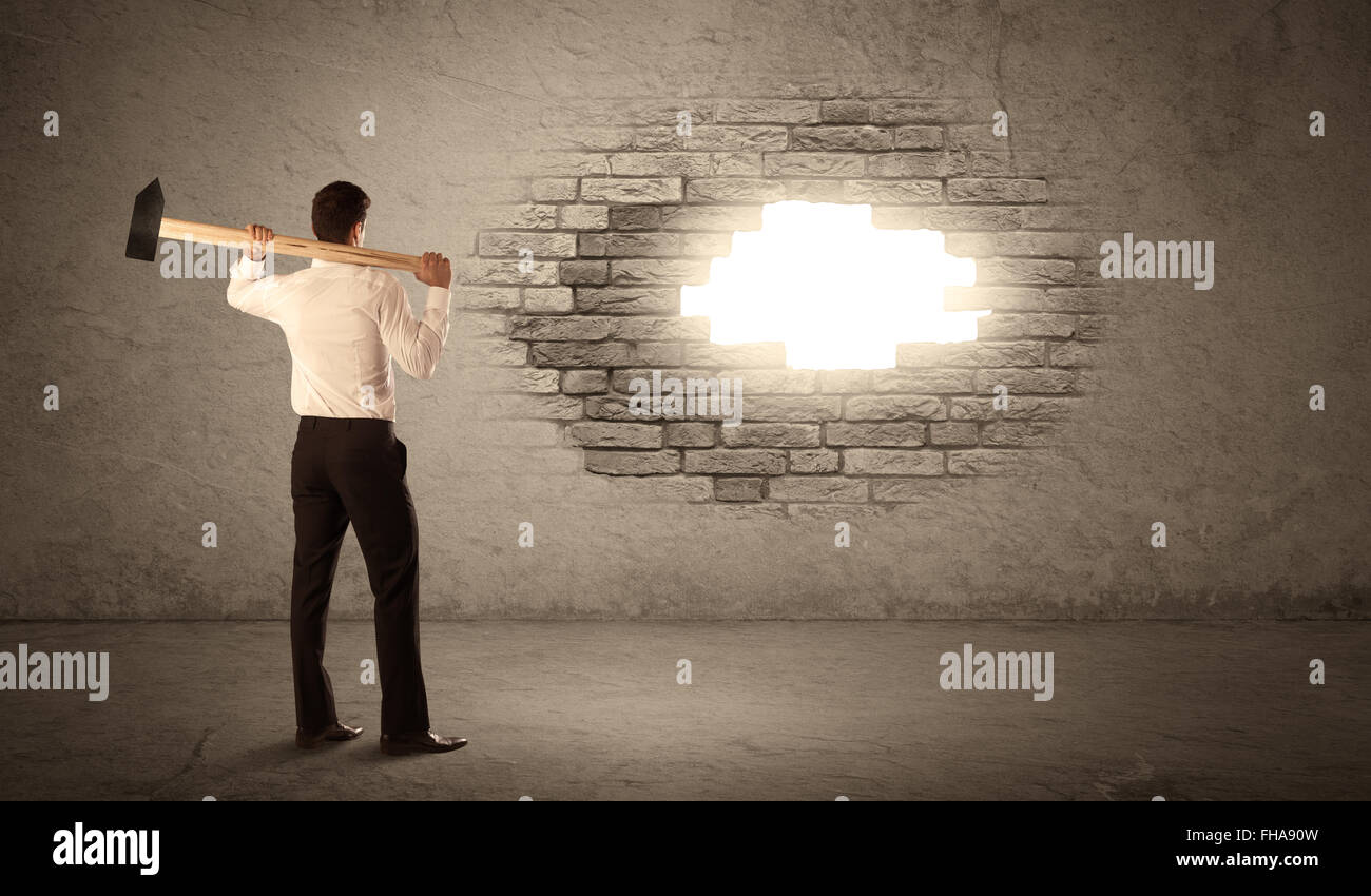 Business man hitting brick wall with hammer and opening a hole Stock ...