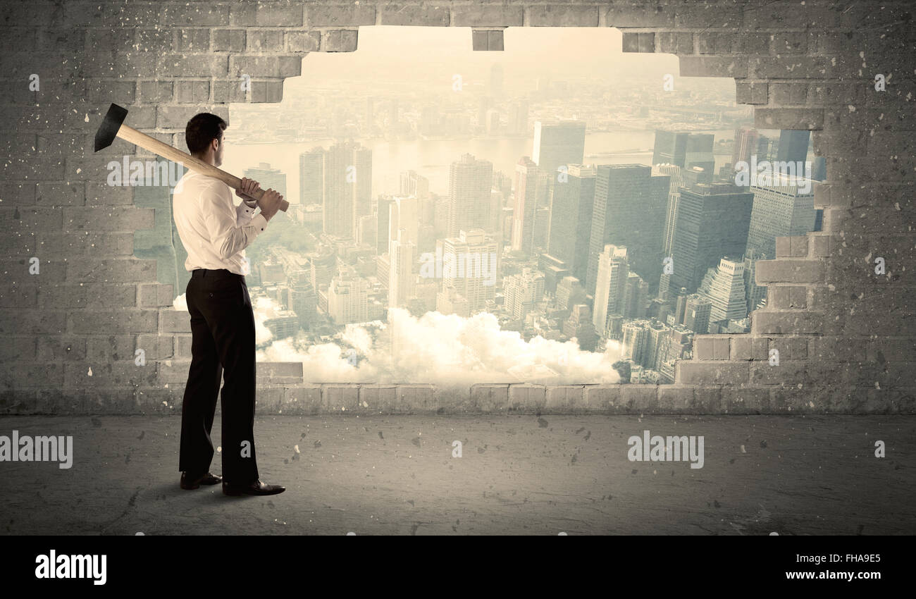 Business man hitting wall with hammer on city view Stock Photo - Alamy