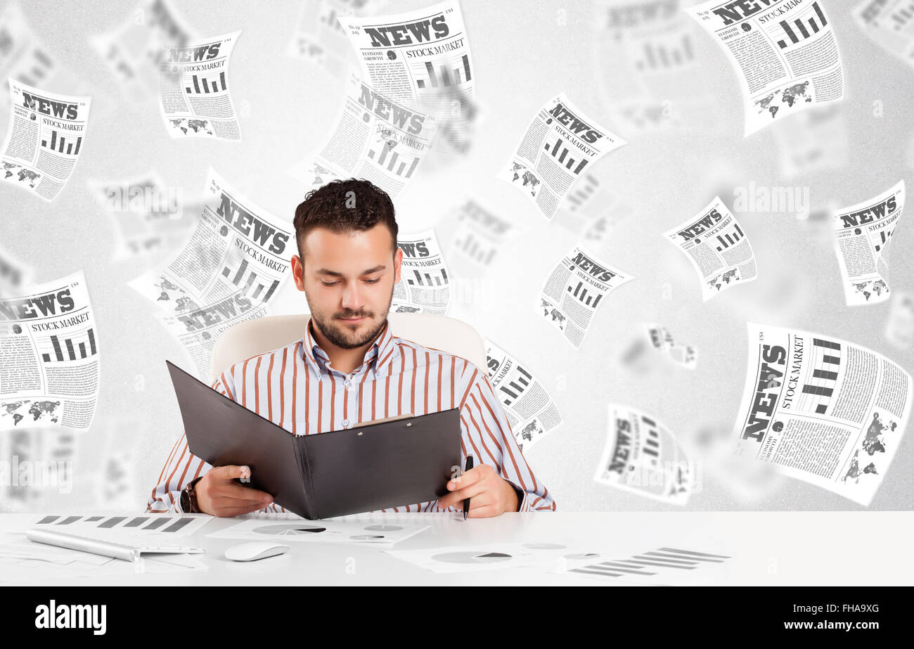 Business man at desk with stock market newspapers Stock Photo - Alamy