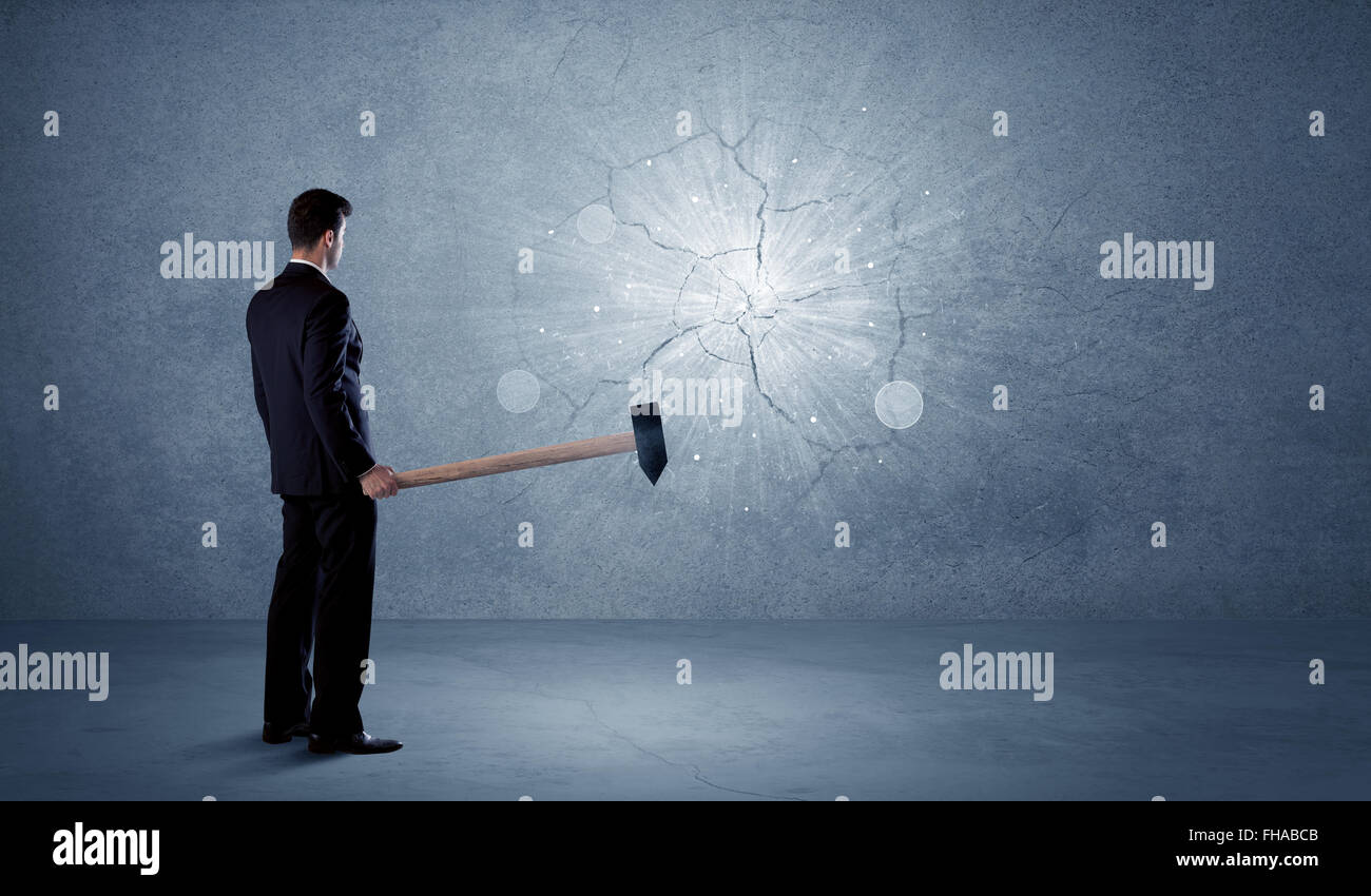 Business man hitting wall with a hammer Stock Photo - Alamy