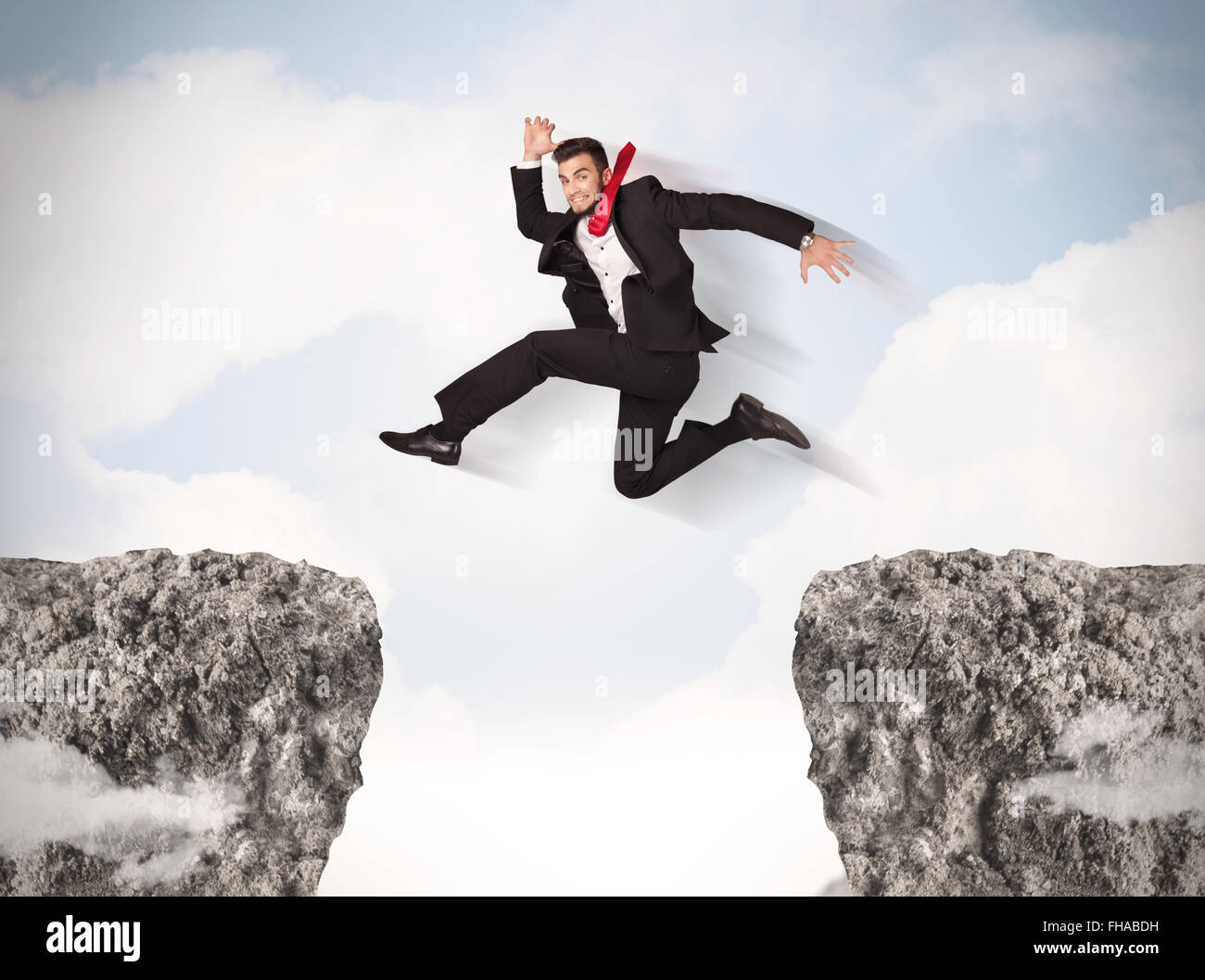Funny business man jumping over rocks with gap Stock Photo - Alamy