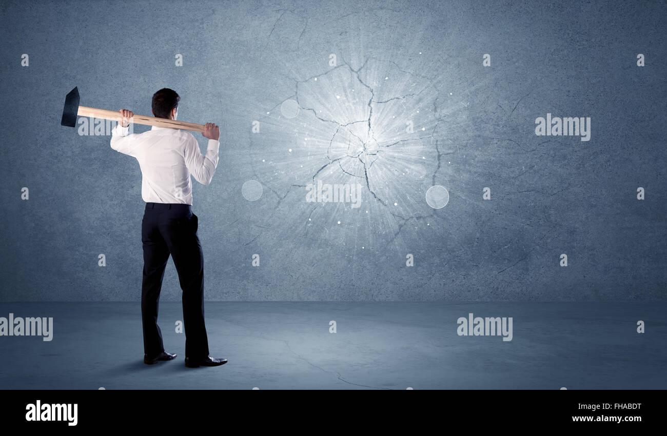 Business man hitting wall with a hammer Stock Photo - Alamy