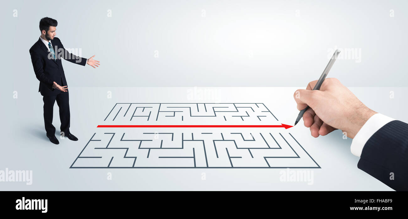Business man looking at hand drawing solution for maze Stock Photo - Alamy