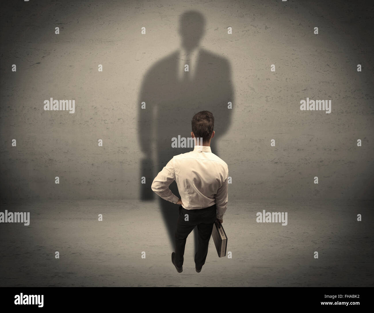 Businessman looking at big shadow concept Stock Photo - Alamy