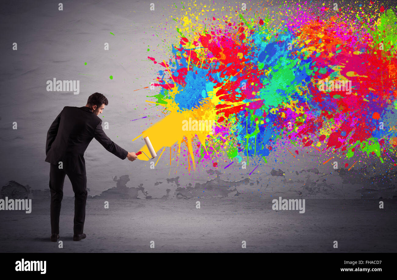 Sales person painting colorful splatter Stock Photo - Alamy