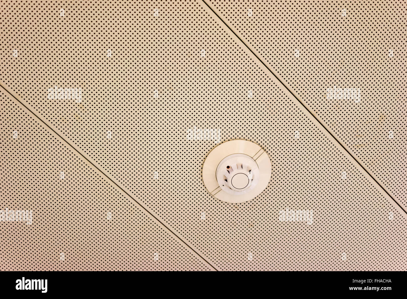 Smoke detector with fire alarm system on dotted ceiling Stock Photo - Alamy