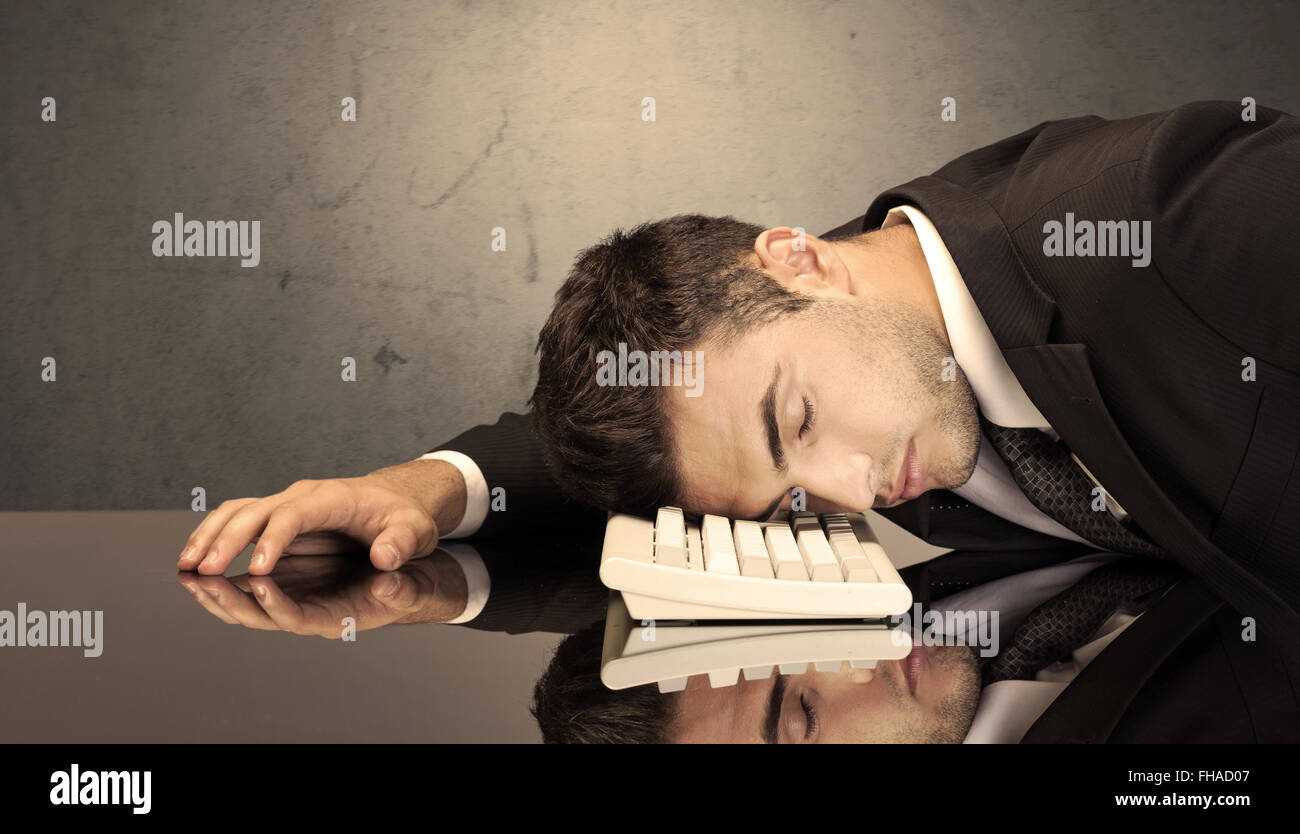 Frustrated businessman's head on keyboard Stock Photo - Alamy