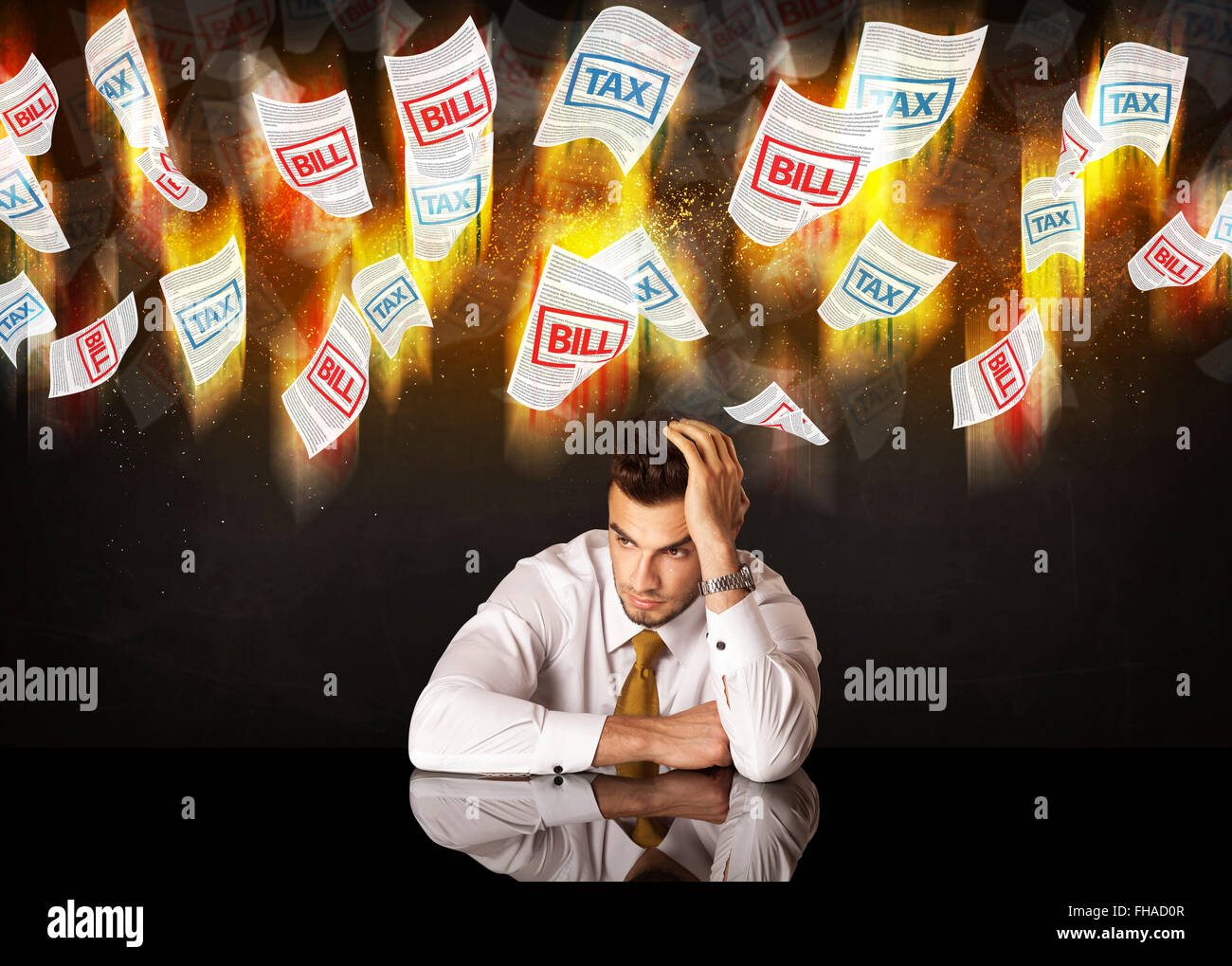 Depressed businessman sitting under burning tax and bill papers Stock ...