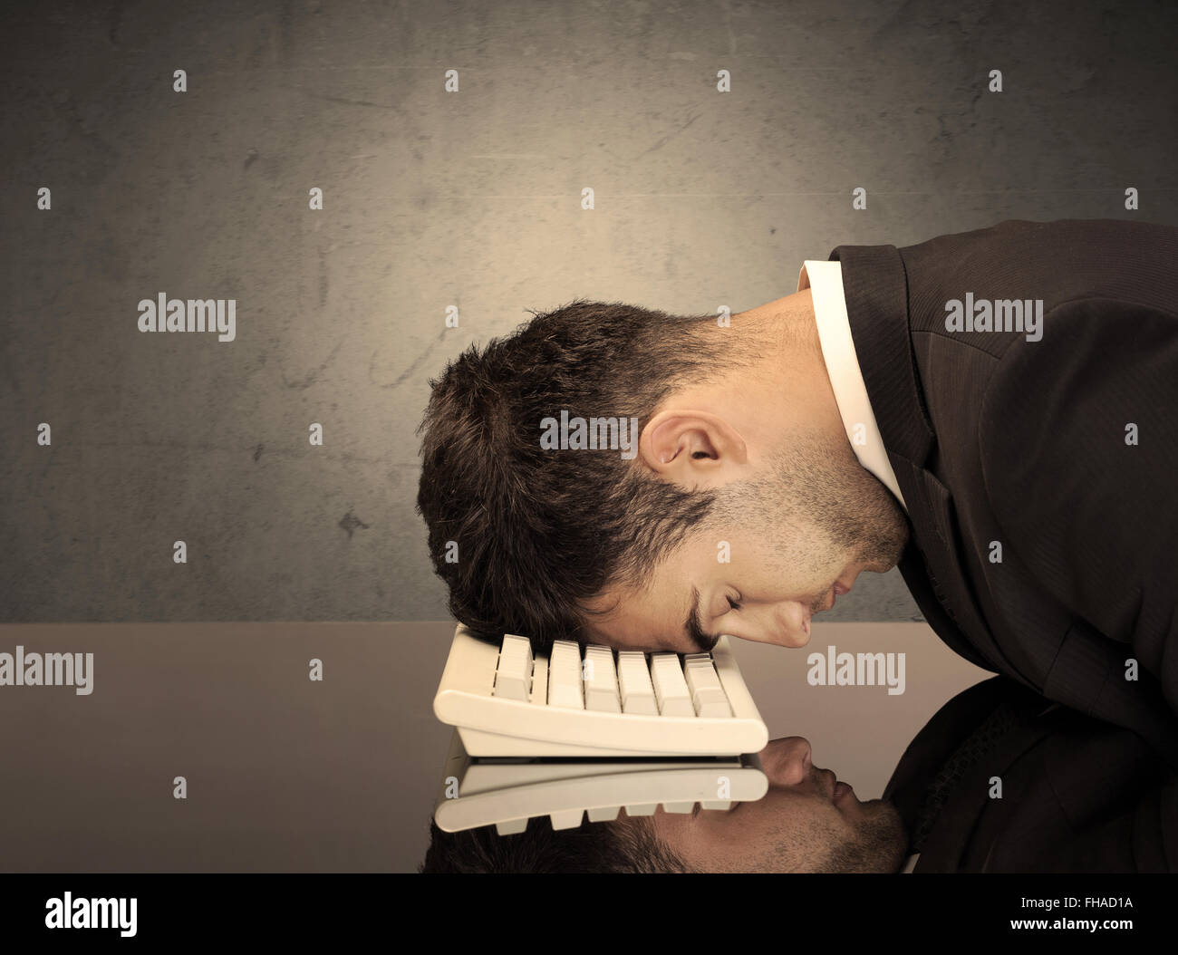 Frustrated businessman's head on keyboard Stock Photo - Alamy