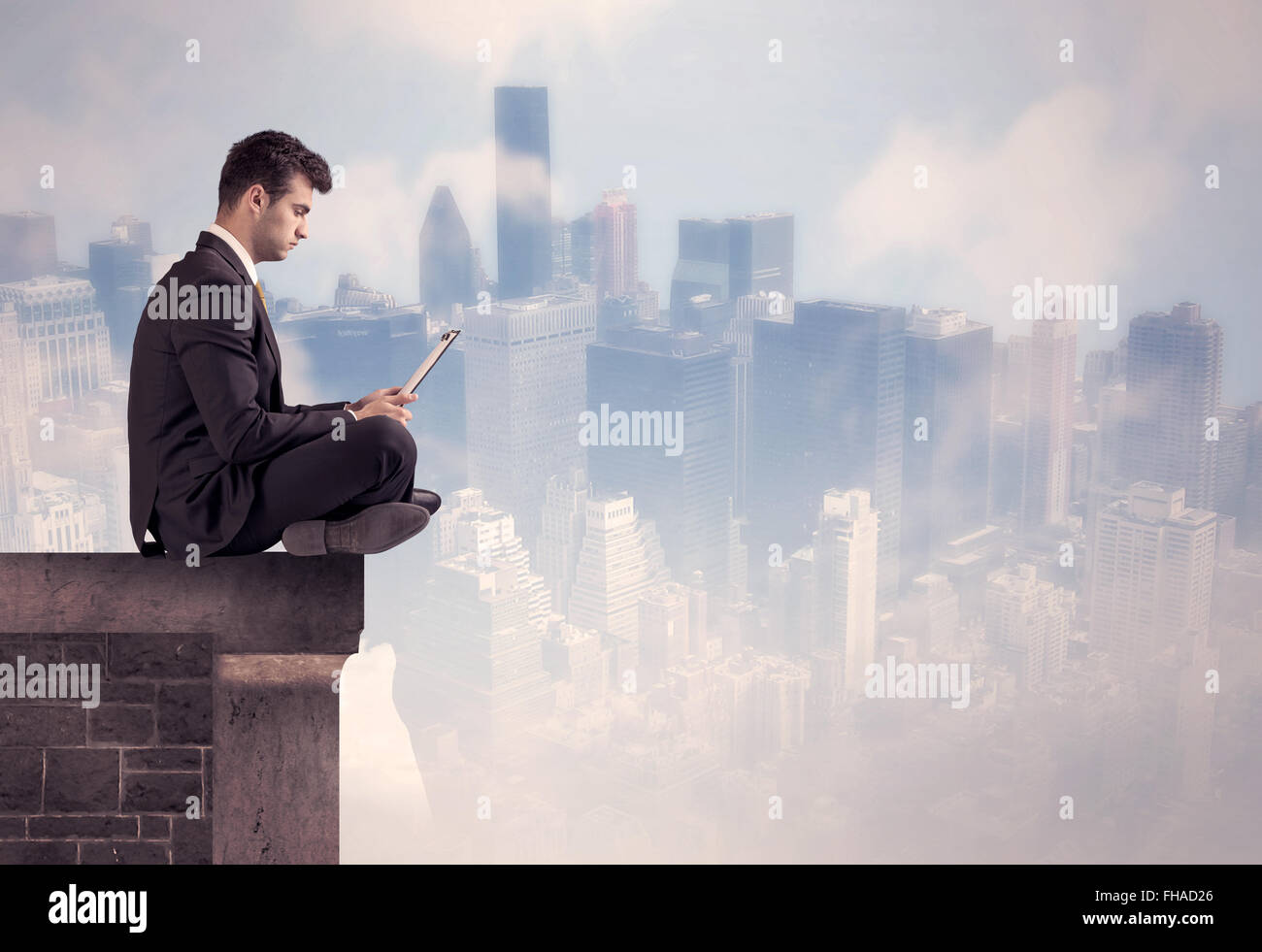 Sales person sitting on top of a tall building Stock Photo - Alamy