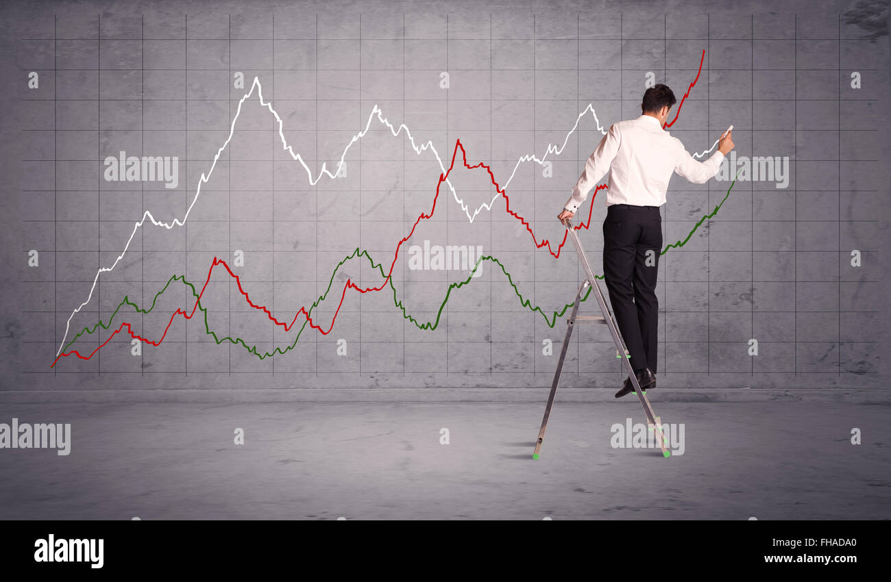 male on ladder drawing chart lines Stock Photo - Alamy