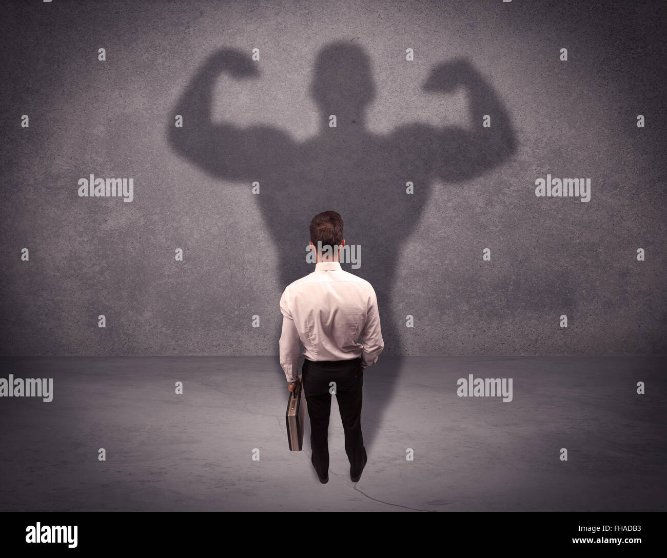 Successful businessman with strong shadow Stock Photo - Alamy