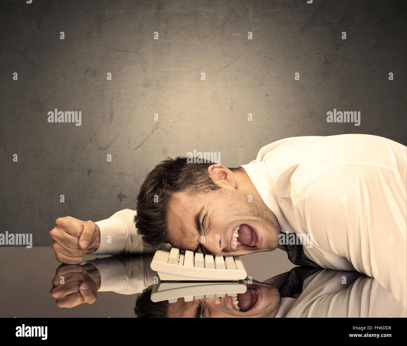 Frustrated businessman's head on keyboard Stock Photo - Alamy