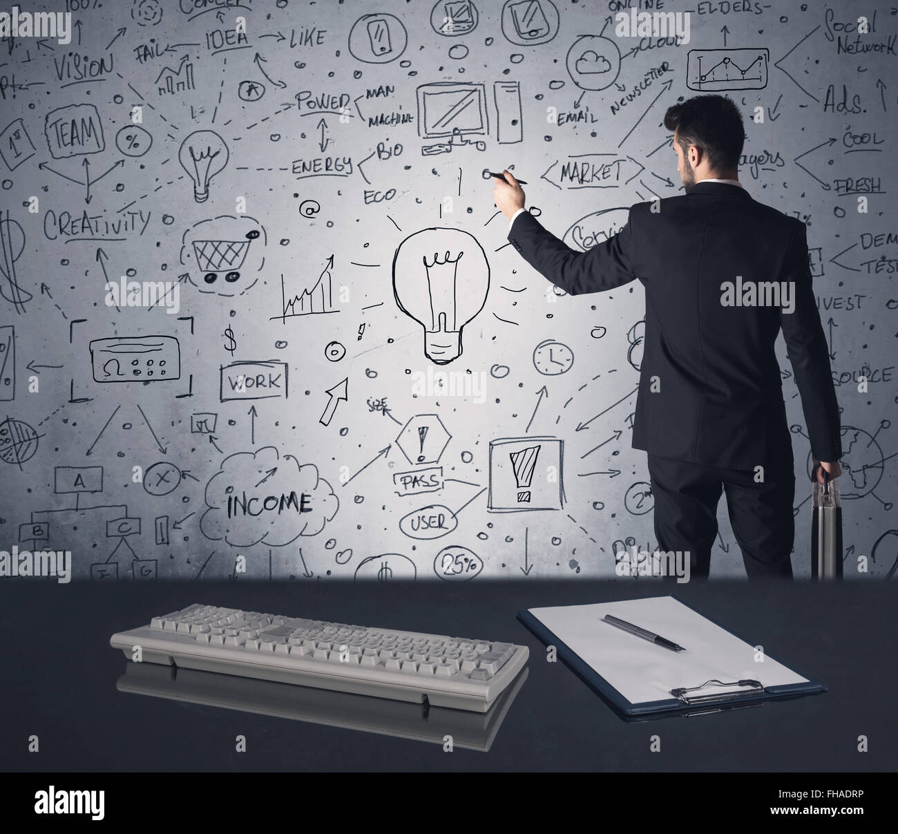 Businessman writing strategy plan on wall Stock Photo - Alamy