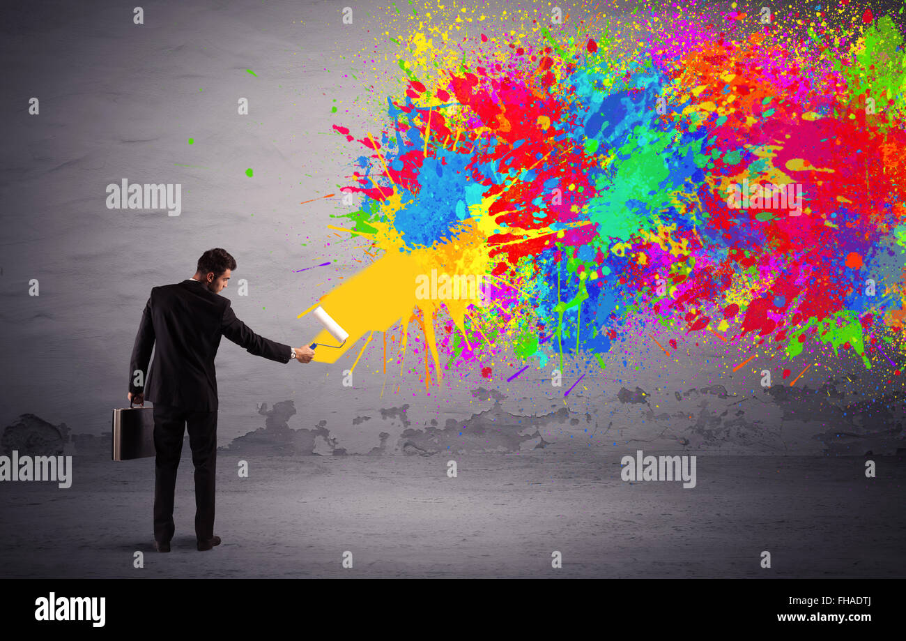 Sales person painting colorful splatter Stock Photo - Alamy