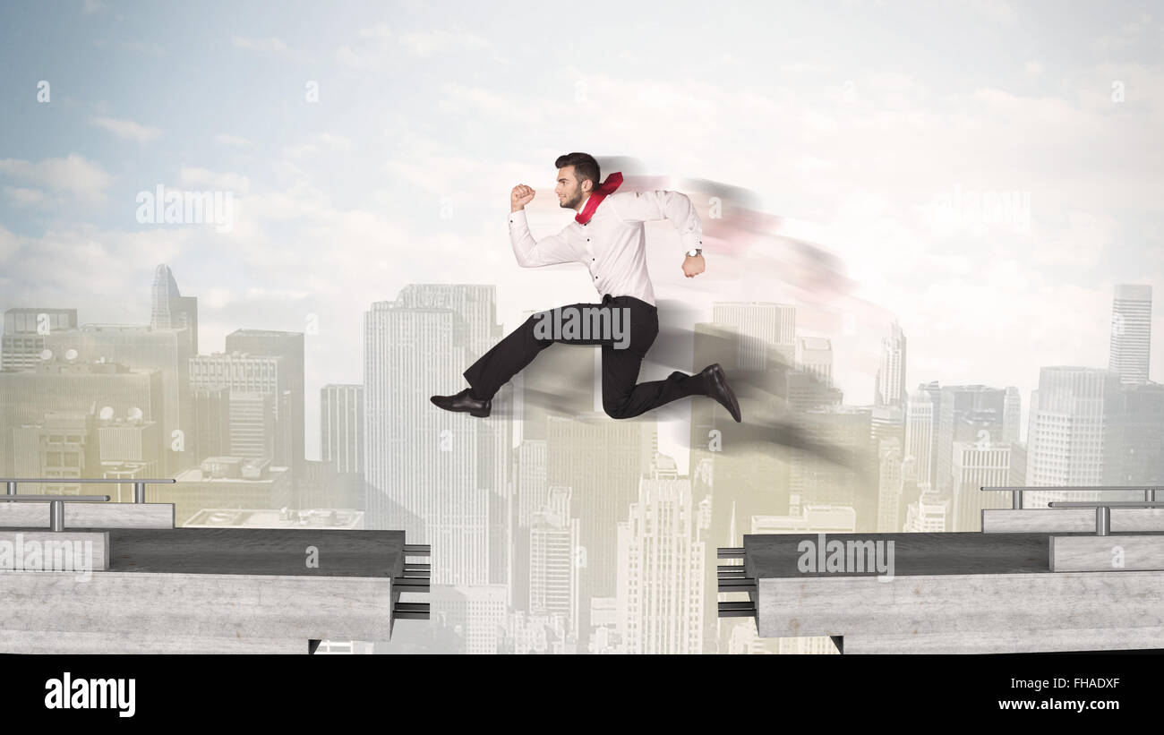 Energetic business man jumping over a bridge with gap Stock Photo - Alamy