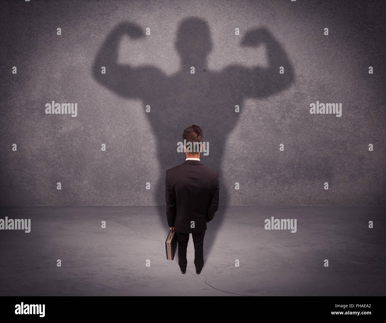 Successful businessman with strong shadow Stock Photo - Alamy