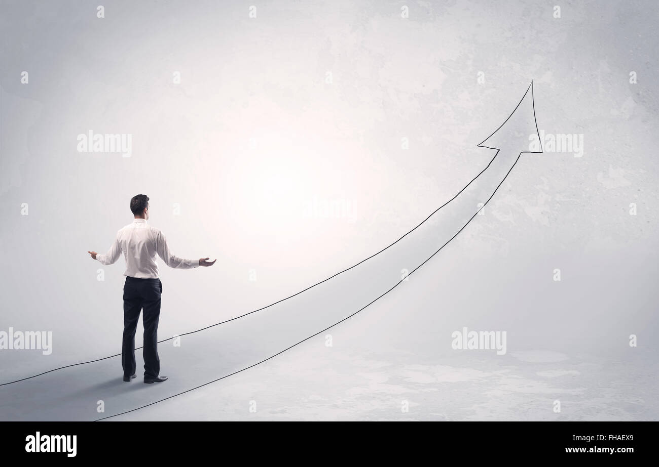 Business man standing on drawn arrow Stock Photo - Alamy