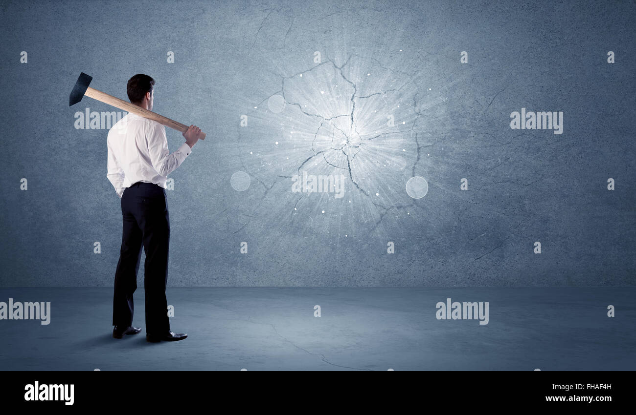 Business man hitting wall with a hammer Stock Photo - Alamy