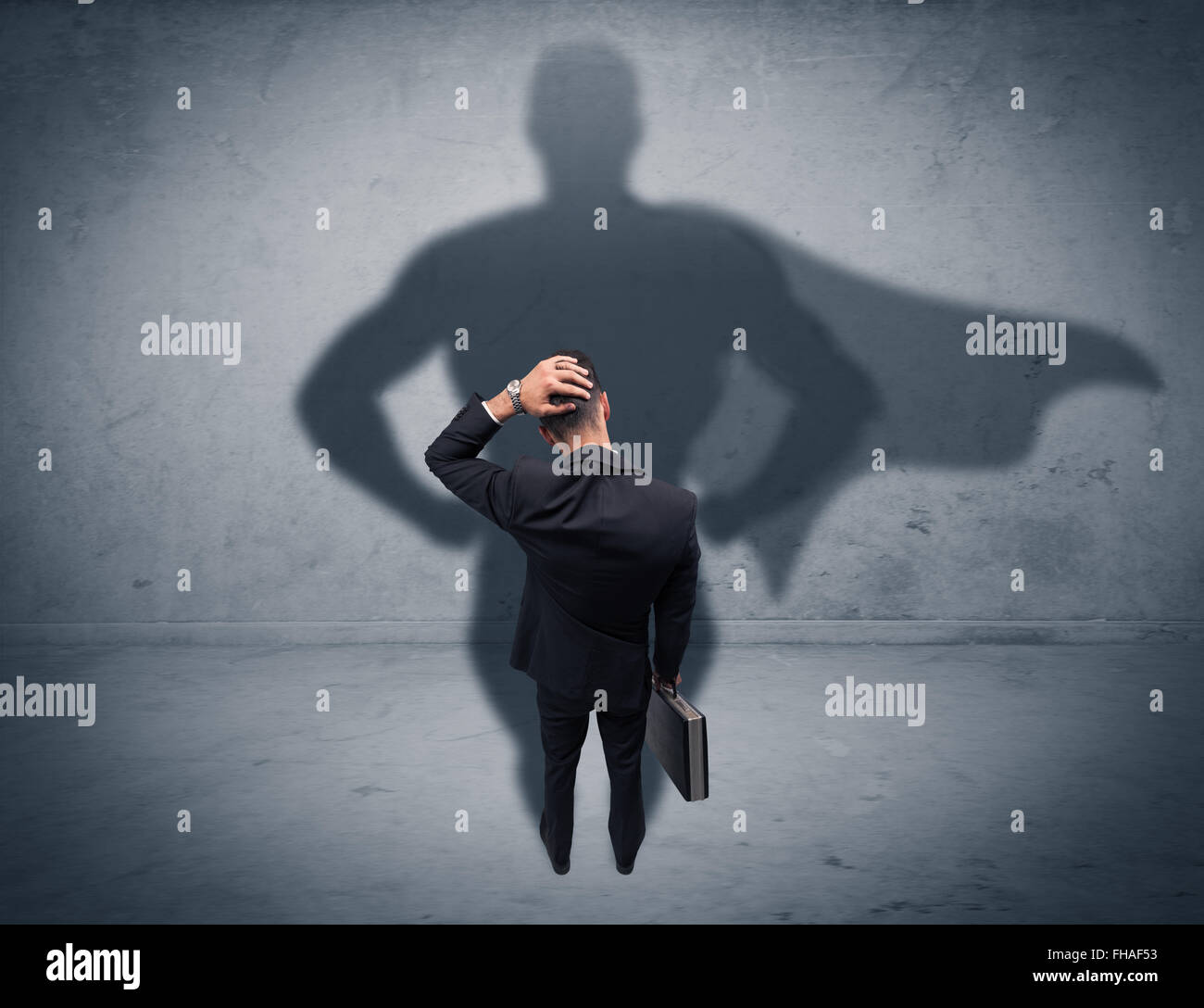 Successful businessman with superhero shadow Stock Photo - Alamy
