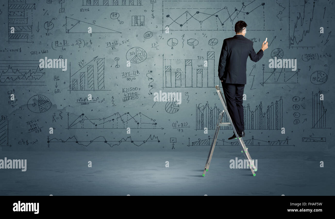 Man on ladder drawing charts Stock Photo - Alamy
