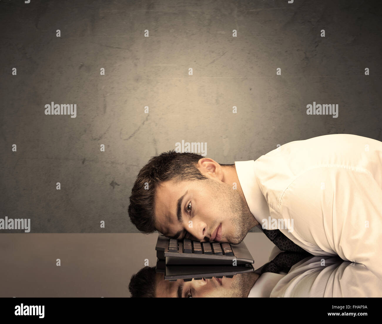 Frustrated businessman's head on keyboard Stock Photo - Alamy