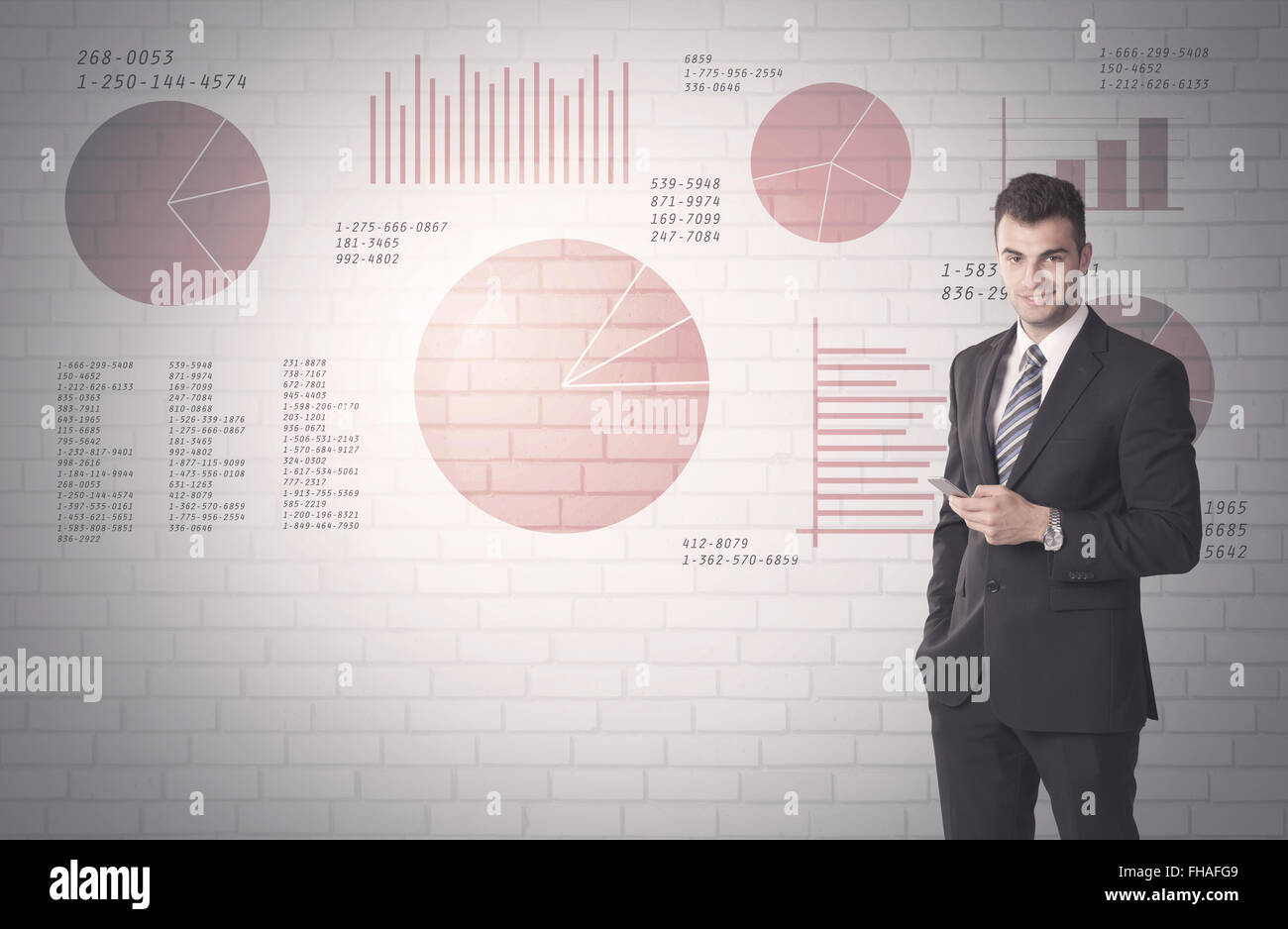Pie charts and numbers on wall with salesman Stock Photo - Alamy